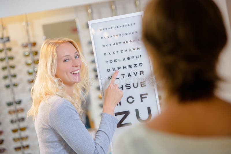 Woman Reading from Eye Test Chart Stock Photo - Image of back, care ...
