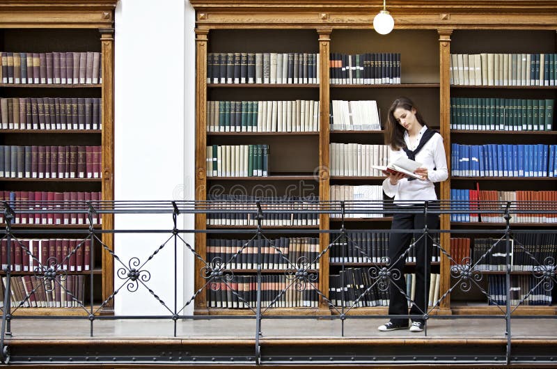 Woman Reading in Front of Bookshelf Stock Photo - Image of knowledge ...