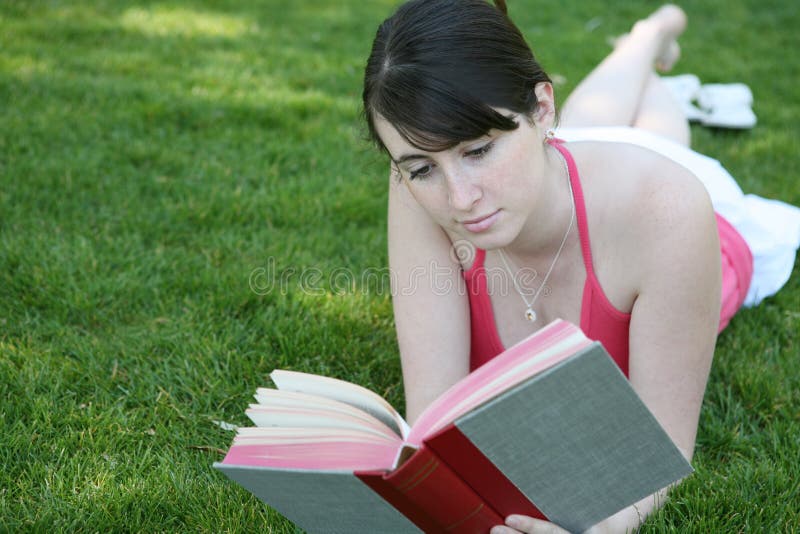 Woman reading on grass stock image. Image of garden, lying - 4847335