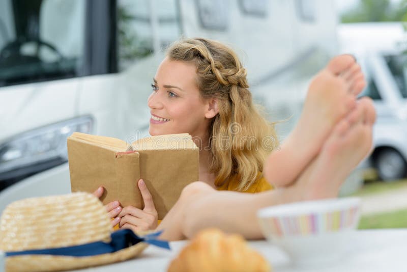 Woman Reading Book in Campervan Campsite Stock Image - Image of book ...