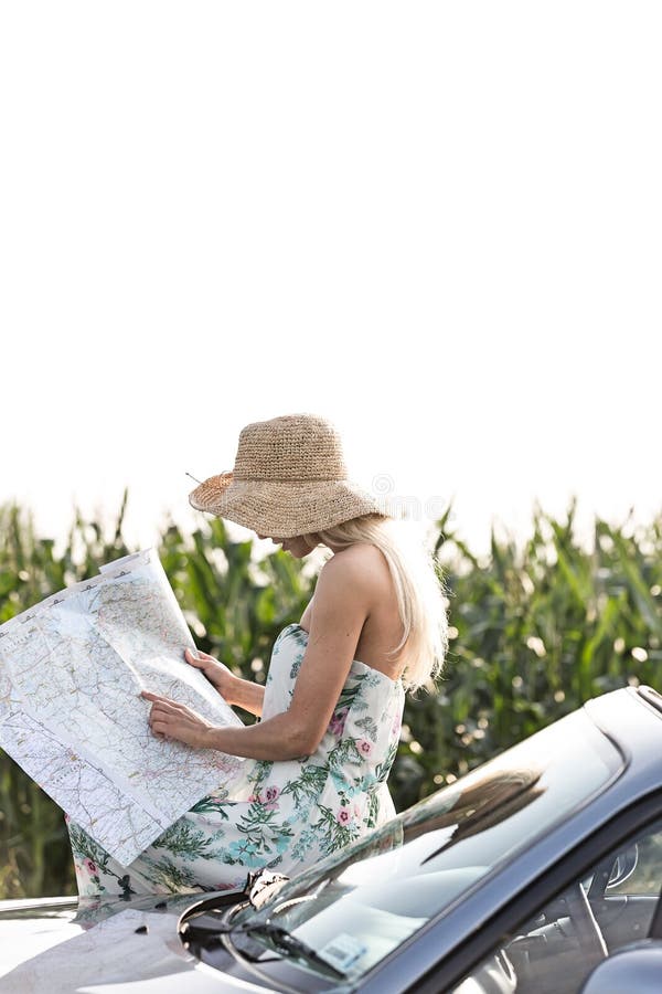 Woman Reading Map while Leaning on Convertible Stock Photo - Image of ...