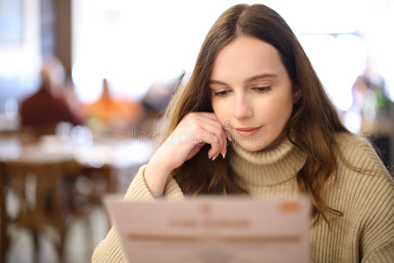 Woman Reading Menu in a Restaurant Stock Photo - Image of choice ...
