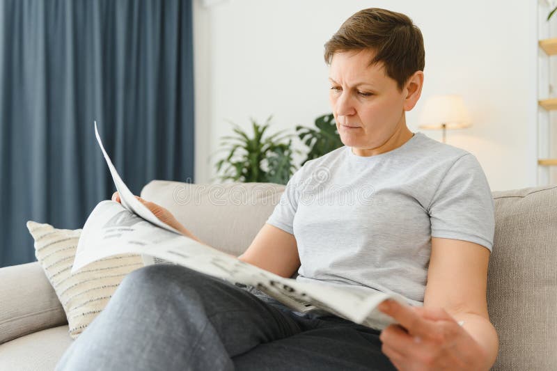 Woman Reading Newspaper at Home Stock Image - Image of couch, business ...