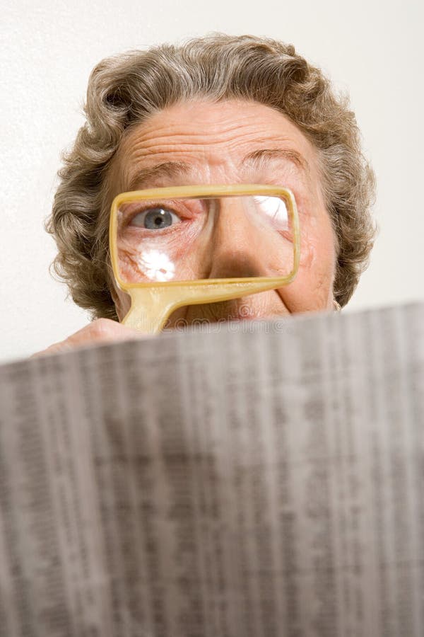 Woman Reading Newspaper with Magnifying Glass Stock Photo - Image of ...