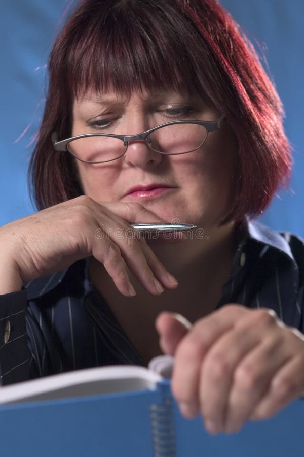 Woman reading notebook 2 stock photo. Image of glasses - 2446886