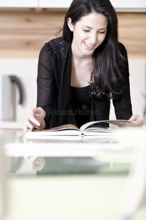 Woman reading recipe book stock photo. Image of morning - 33521728