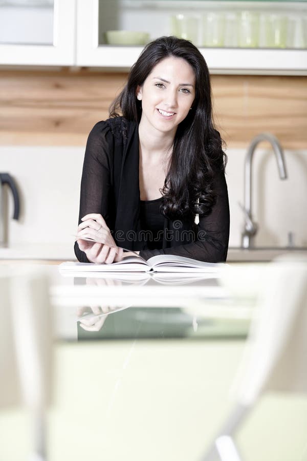 Woman reading recipe book stock photo. Image of studying - 33521732