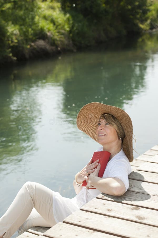Woman reading by the river stock image. Image of pursuit - 25945517