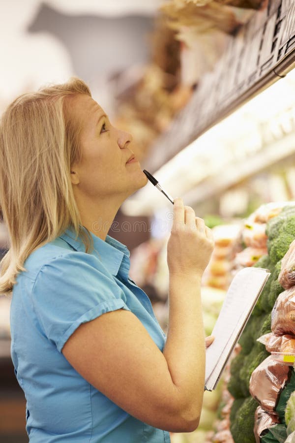 Woman Reading Shopping List in Supermarket Stock Photo - Image of food ...
