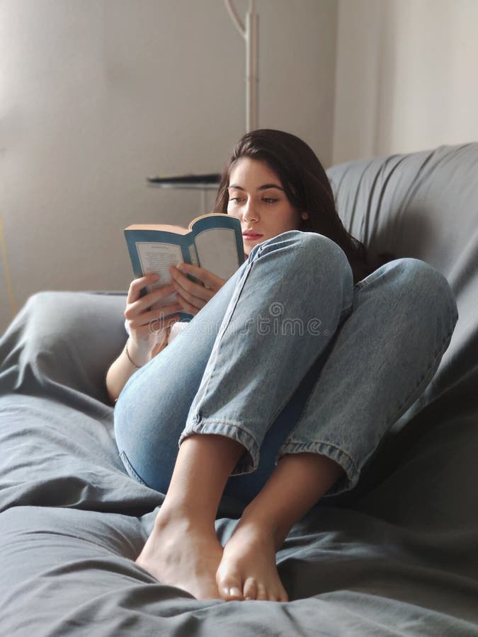 Woman Reading on a Sofa in a House Stock Photo - Image of casual ...