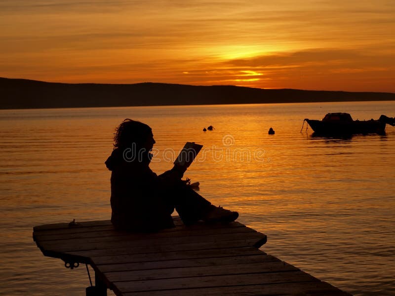 Woman Reading In The Sunset Royalty Free Stock Image - Image: 22662006