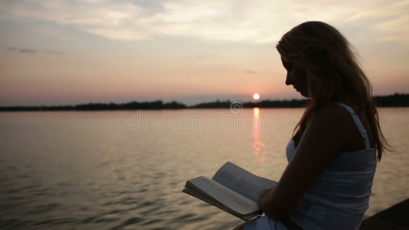 Woman reading at sunset stock video. Video of adolescence - 43946471