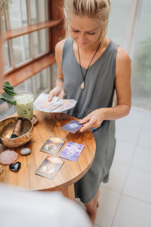 Woman is Reading Tarot Cards with a Cusomer in Cafe Stock Photo - Image ...