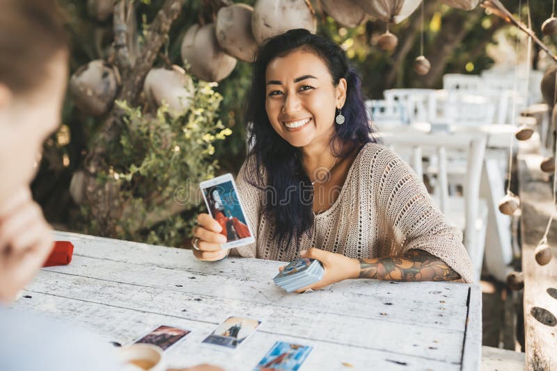 Woman is Reading Tarot Cards with a Customer Outdoors Stock Photo ...