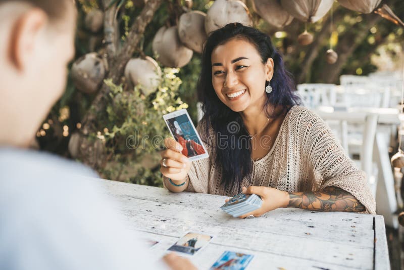 Woman is Reading Tarot Cards with a Customer Outdoors Stock Photo ...