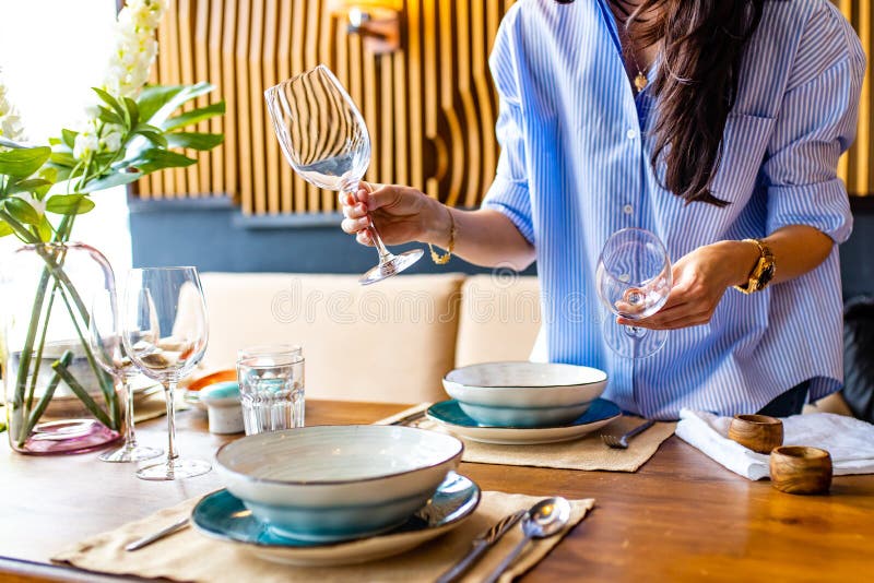 A Woman Reading To Date Setting a Table in Her House Stock Photo ...