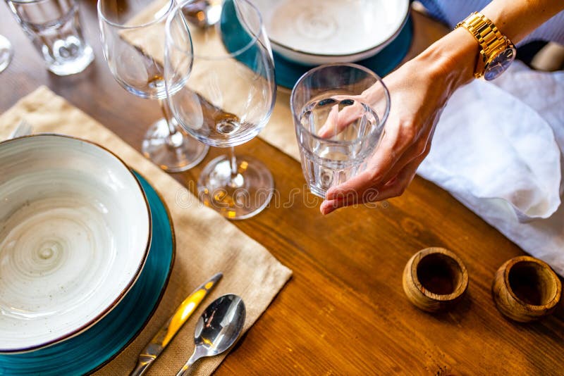 A Woman Reading To Date Setting a Table in Her House Stock Photo ...