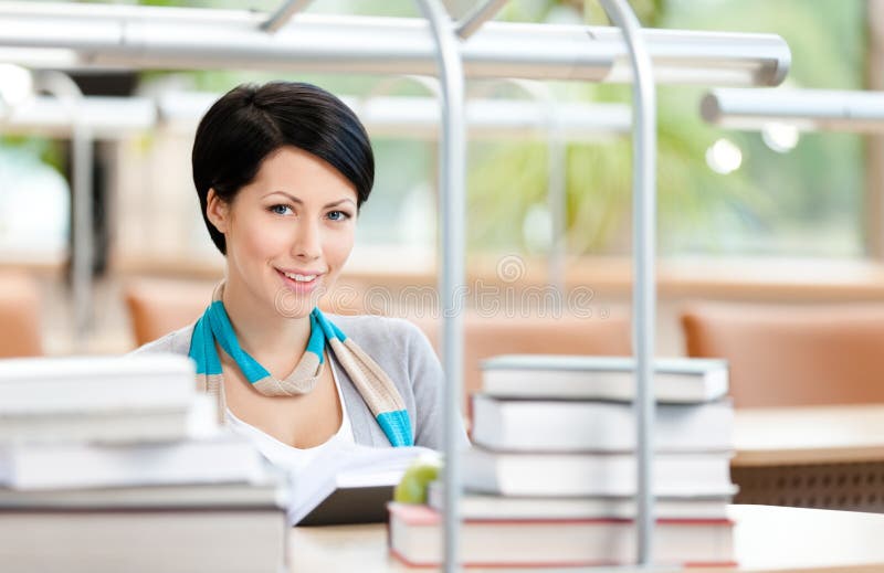 Woman reads at the library stock image. Image of beautiful - 26756657