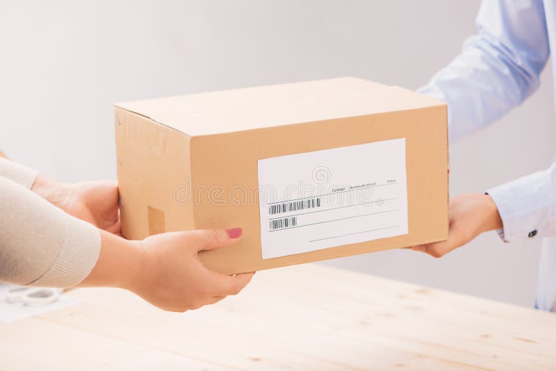 Woman Receiving Package from a Delivery Man Stock Photo - Image of ...