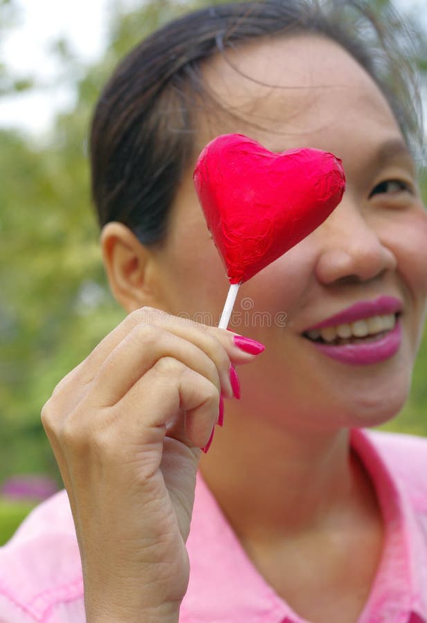 Woman with red candy stock photo. Image of candy, wedding - 65798392