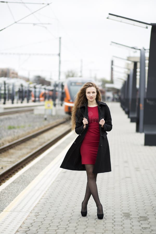 Woman at Red Dress and Black Overcoat Stock Image - Image of long ...