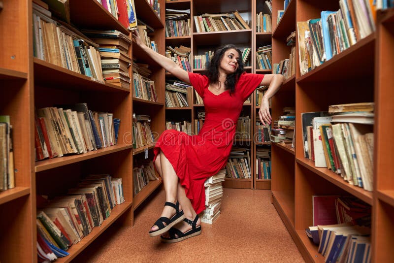 Woman in Red Dress in a Library Stock Photo - Image of information ...