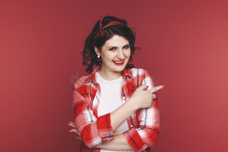 Woman with Red Lips Pointing Something in Colored Studio. Stock Photo ...