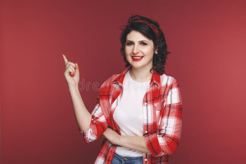 Woman with Red Lips Pointing Something in Colored Studio. Stock Photo ...