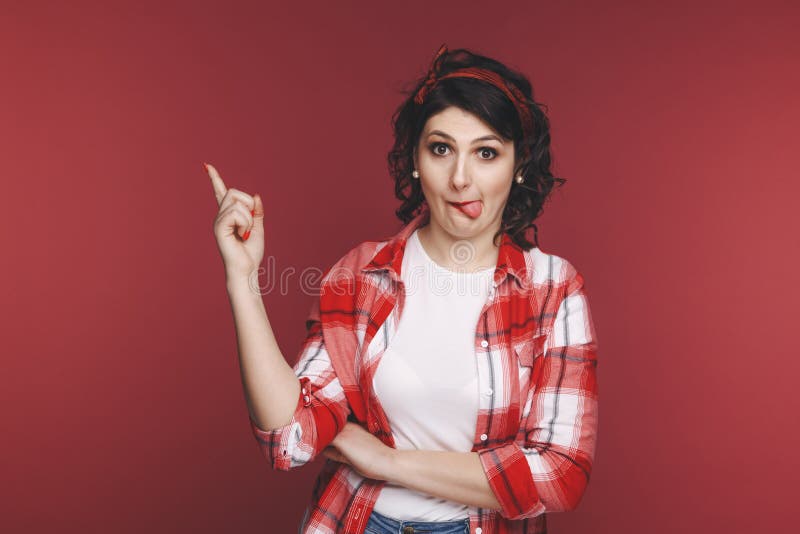 Woman with Red Lips Pointing Something in Colored Studio. Stock Image ...