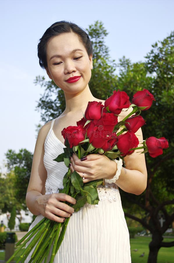 Woman with Red Roses in the Park Stock Photo - Image of bouquet, bunch ...
