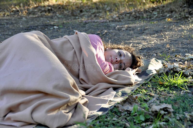 Woman Refugee Sleeping on the Ground Covered with a Rug Stock Photo ...