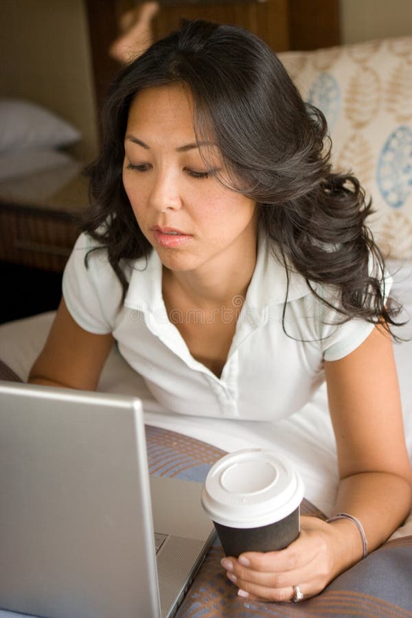 Woman Relaxing on Bed Using Laptop Computer Stock Image - Image of ...