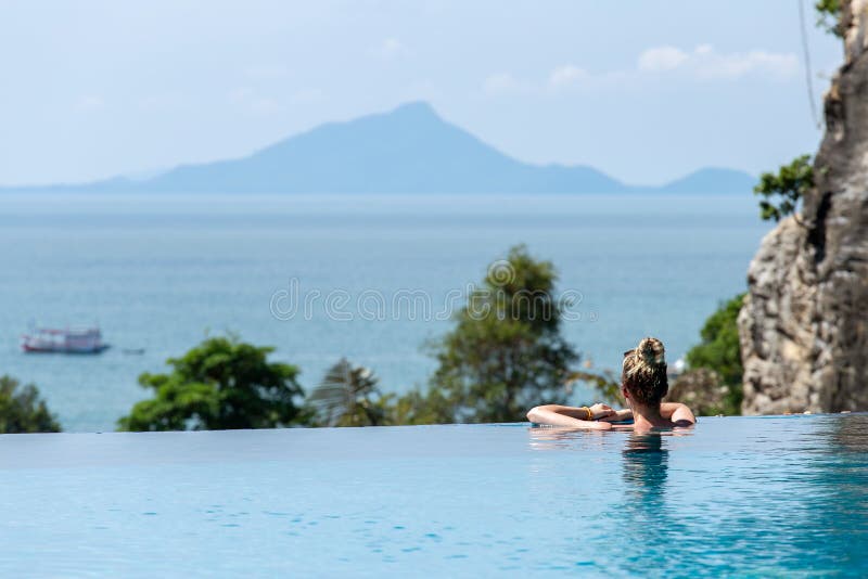 Woman Relaxing in Infinity Swimming Pool Looking at View Editorial ...