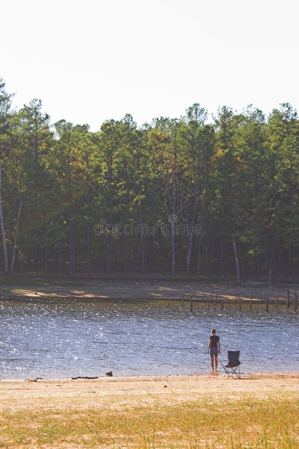 Woman relaxing by lake stock photo. Image of solitary - 3435448