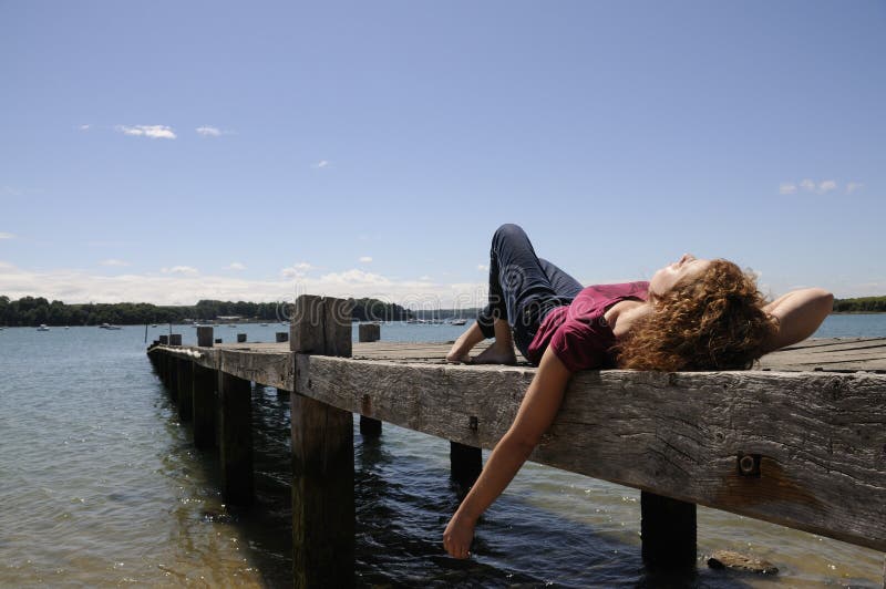 Woman Relaxing on Landing Stage Stock Photo - Image of deck, nautical ...