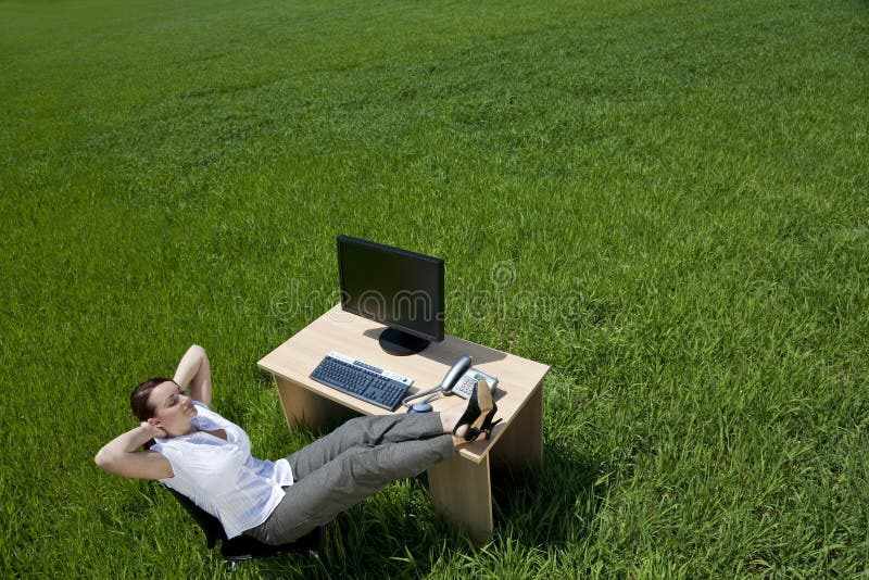 Woman Relaxing at an Office Desk in a Green Field Stock Photo - Image ...