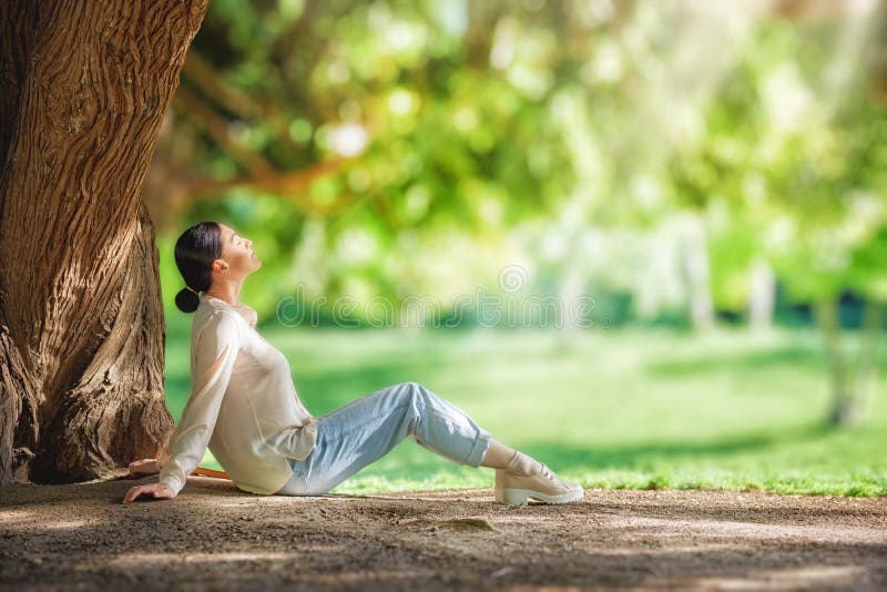 Woman Relaxing Under Big Tree Stock Photo - Image of comfortable ...