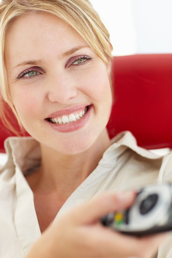 Woman with remote control stock image. Image of chair - 21288617