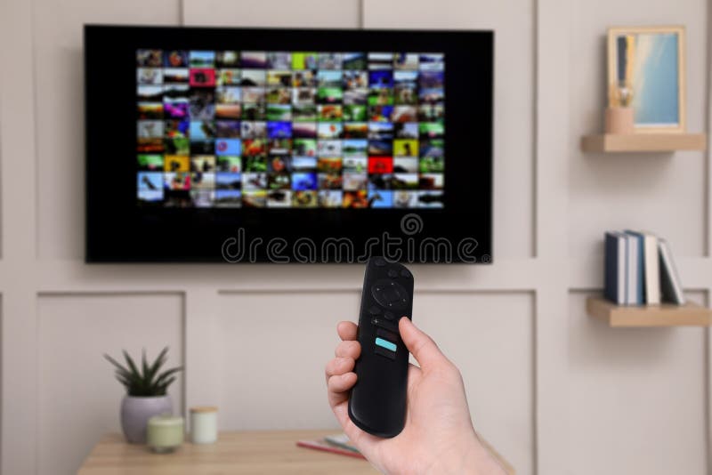 Woman with Remote Control Changing Channels while Watching TV at Home ...