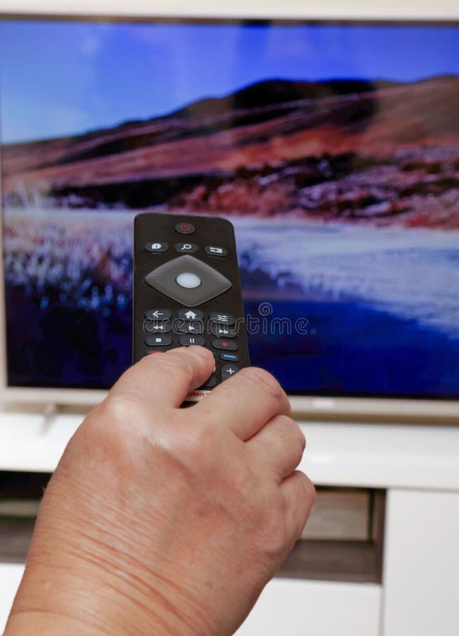 Woman with Remote Control in Hand Changing TV Channels Stock Photo ...