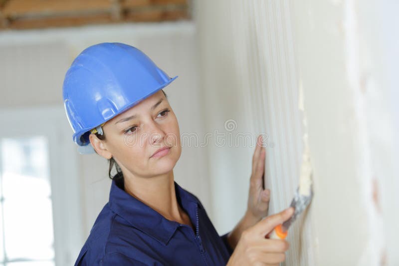 Woman removing wall paper stock photo. Image of removing - 276720926
