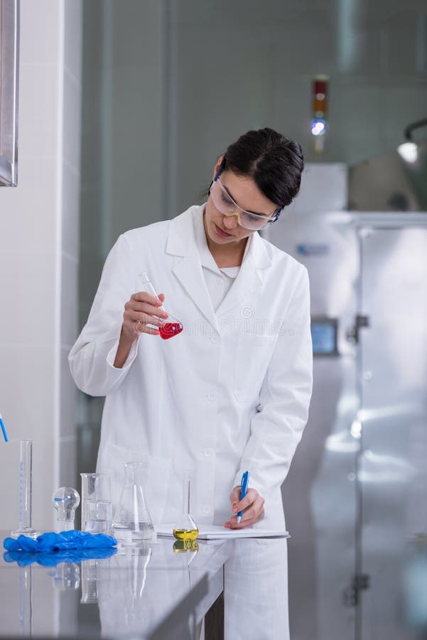 Woman Researcher Doing a Lab Test and Making Notes Stock Image - Image ...