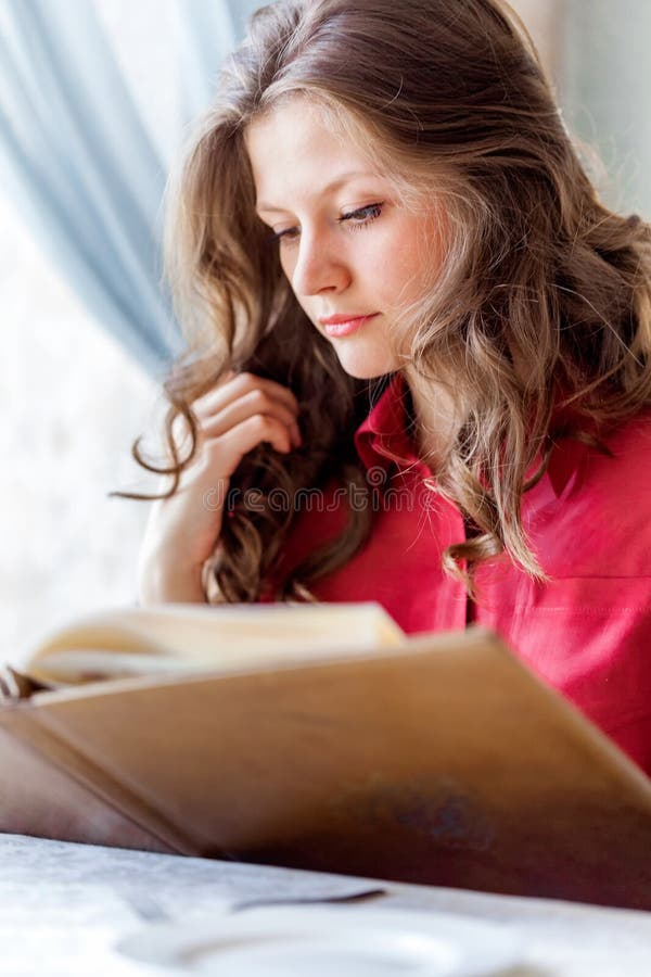 A Woman in a Restaurant with the Menu in Hands Stock Photo - Image of ...