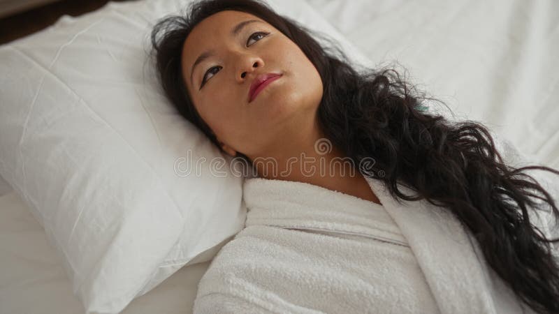 Woman Resting in Bed Wearing a White Robe in a Bedroom Stock Video ...
