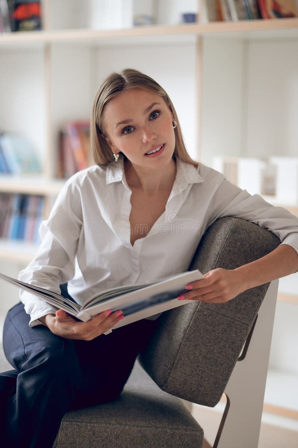 Woman Resting at Home Reading Book in Modern Home Interior. Stock Image ...