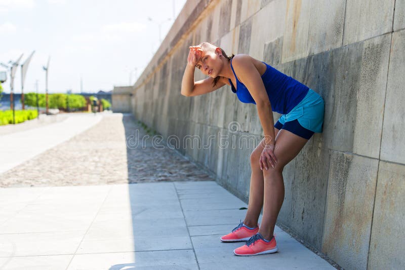 Woman Resting after Run by the Wall. Stock Photo - Image of healthy ...