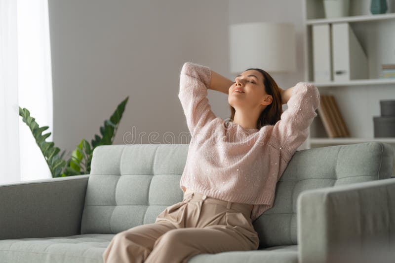 Woman resting on a sofa stock photo. Image of clean - 242279568