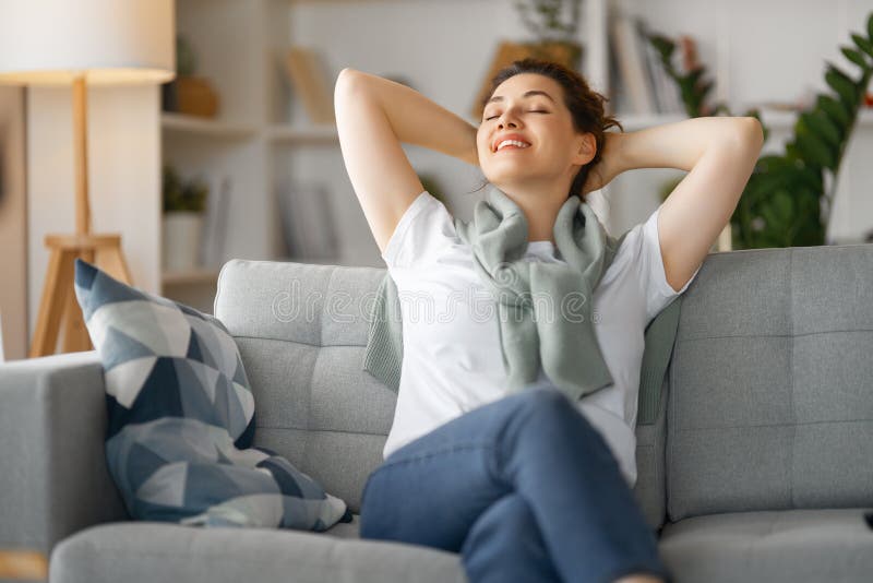 Woman resting on a sofa stock photo. Image of clean - 246476388