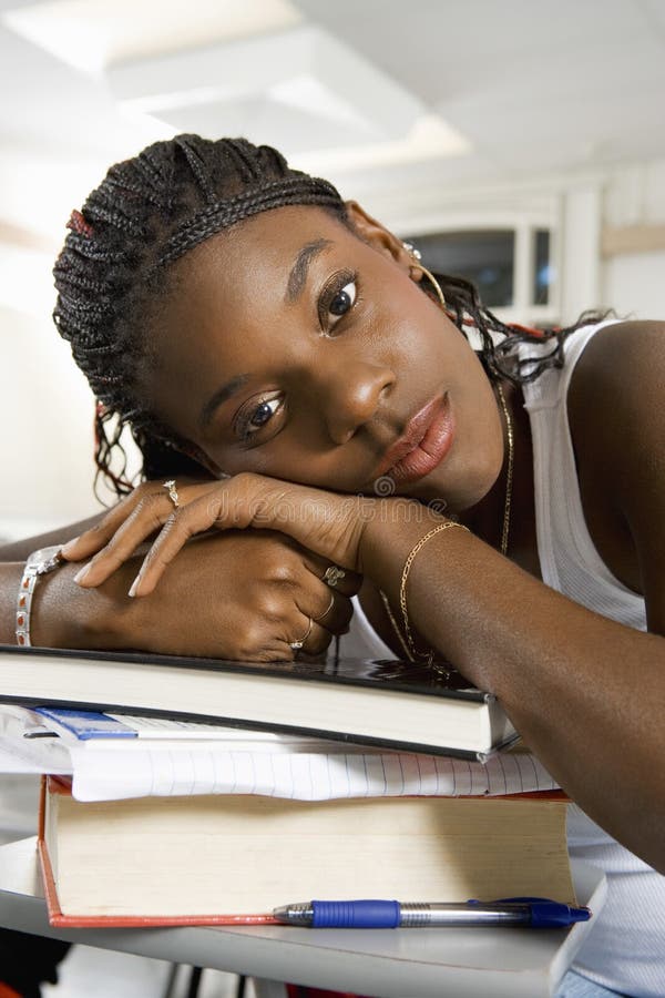 Woman Resting on Stack of Books in Classroom Stock Image - Image of ...