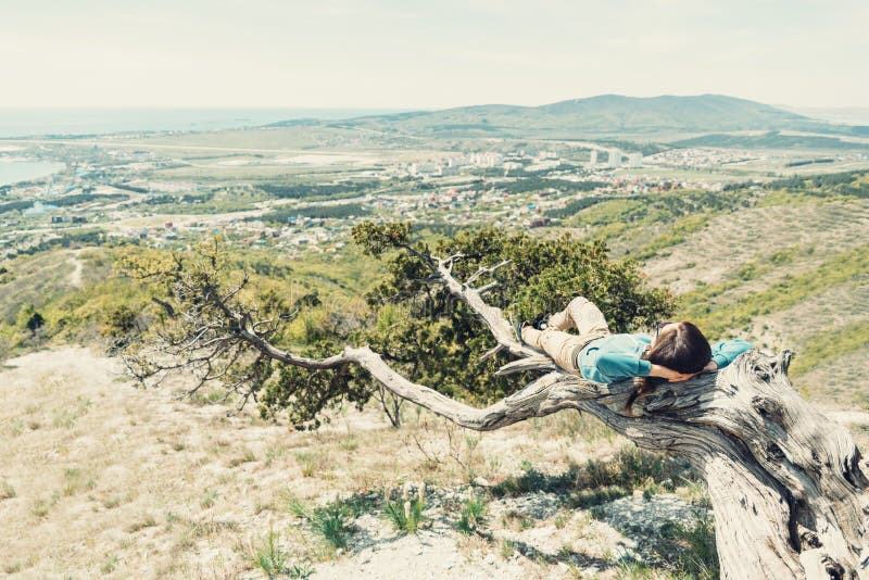 Woman resting on tree stock image. Image of relaxation - 76455541